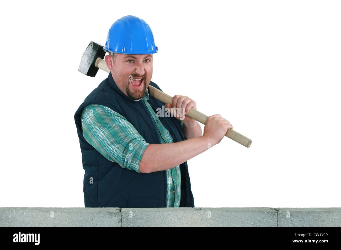Builder hitting a wall with a sledgehammer Stock Photo - Alamy