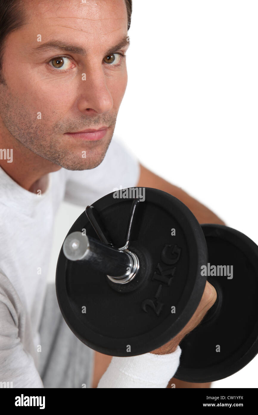 Young man lifting weights Stock Photo - Alamy