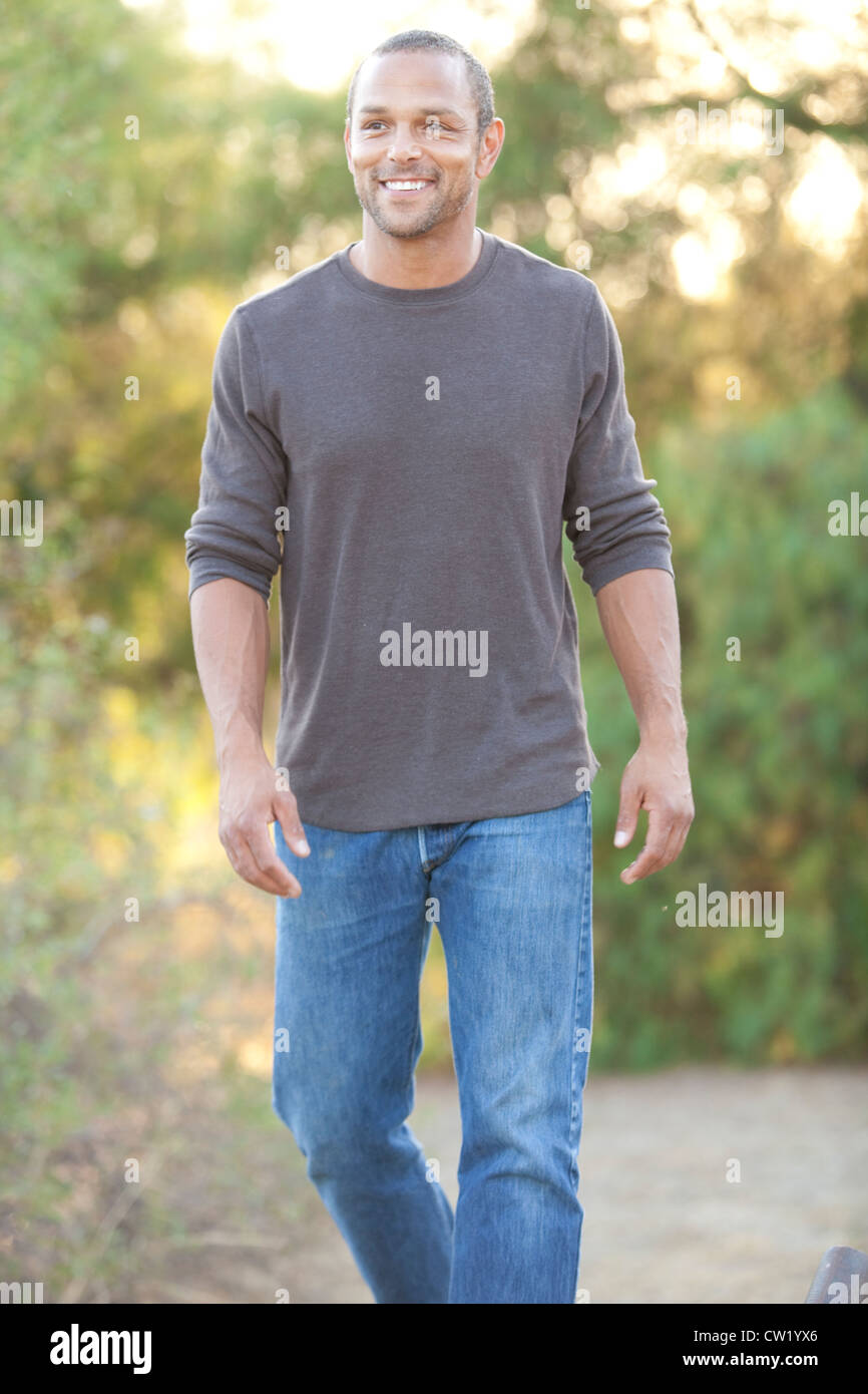 Man walking through nature path. Sitting in the golden sun Stock Photo ...