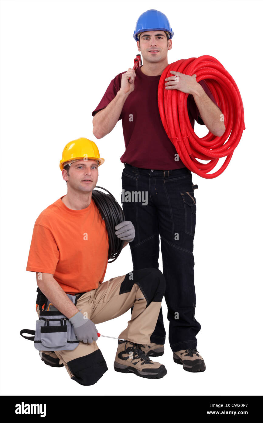A team of construction workers with their tools and building materials ...