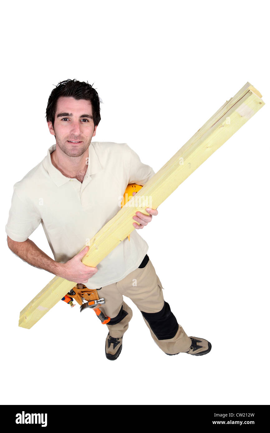 Man carrying timber Stock Photo - Alamy