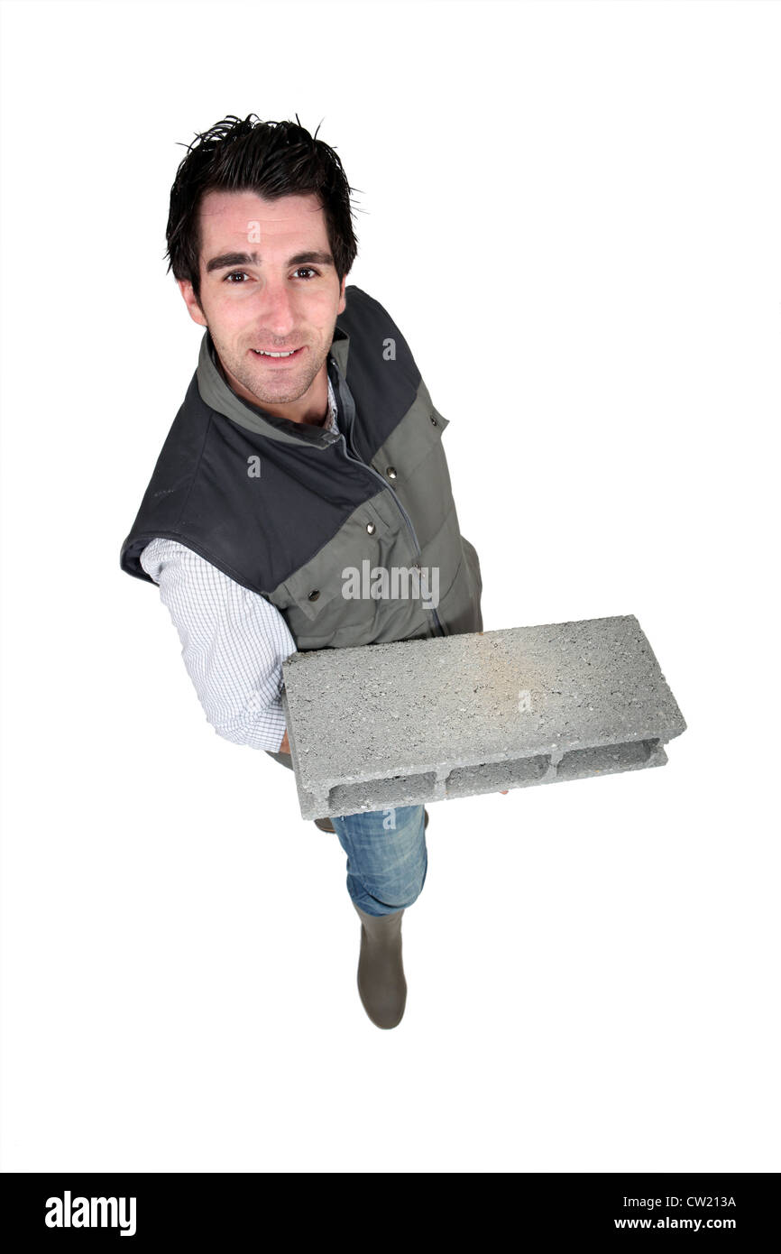 bricklayer standing with concrete block against white background Stock ...