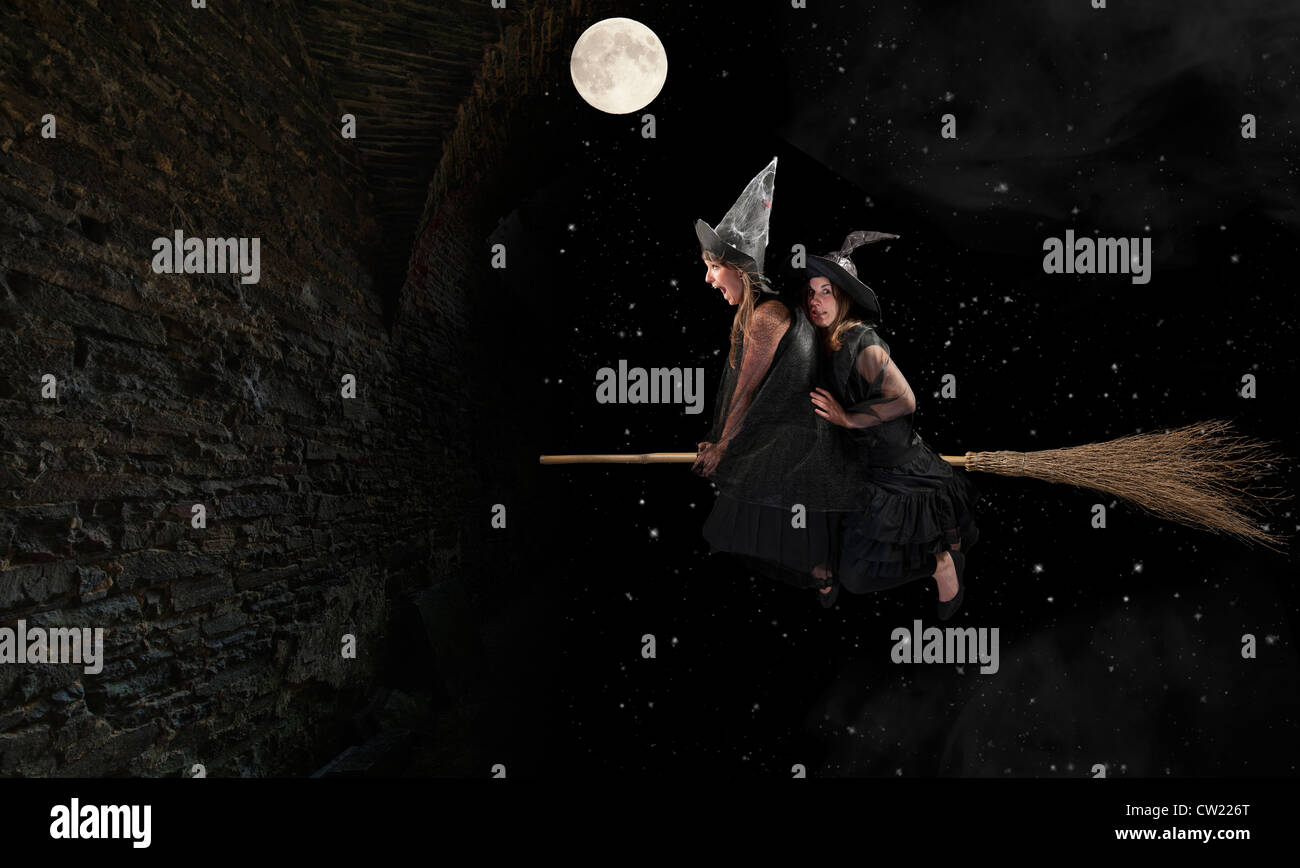 two halloween witches flying on a broom Stock Photo - Alamy