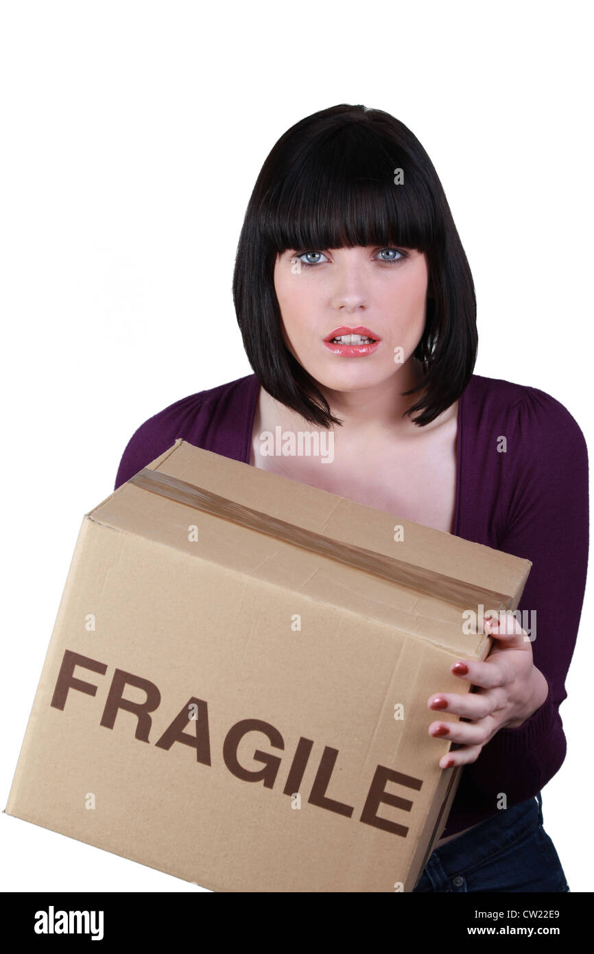 Woman carrying a heavy box Stock Photo - Alamy