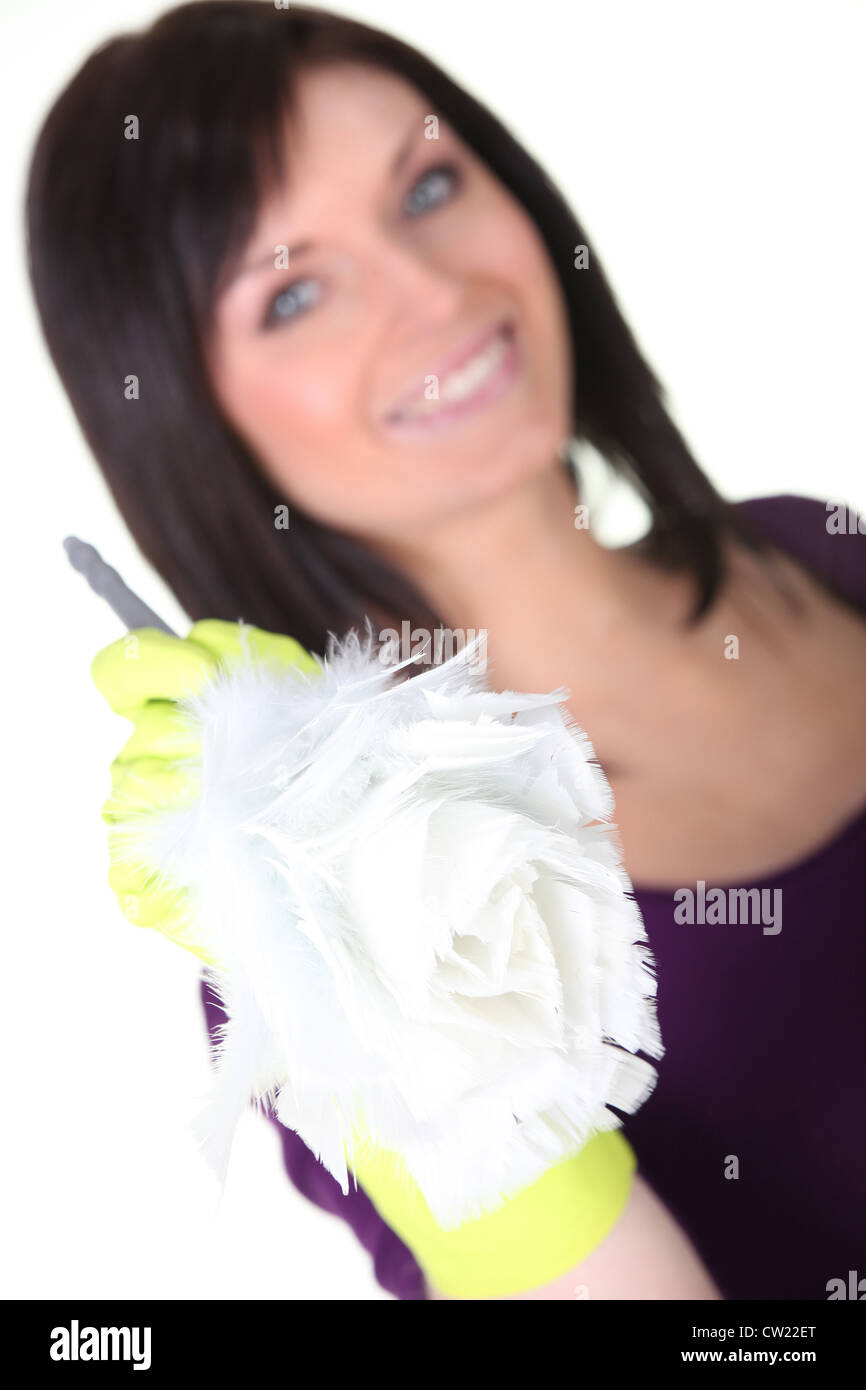 Brunette holding a duster Stock Photo - Alamy
