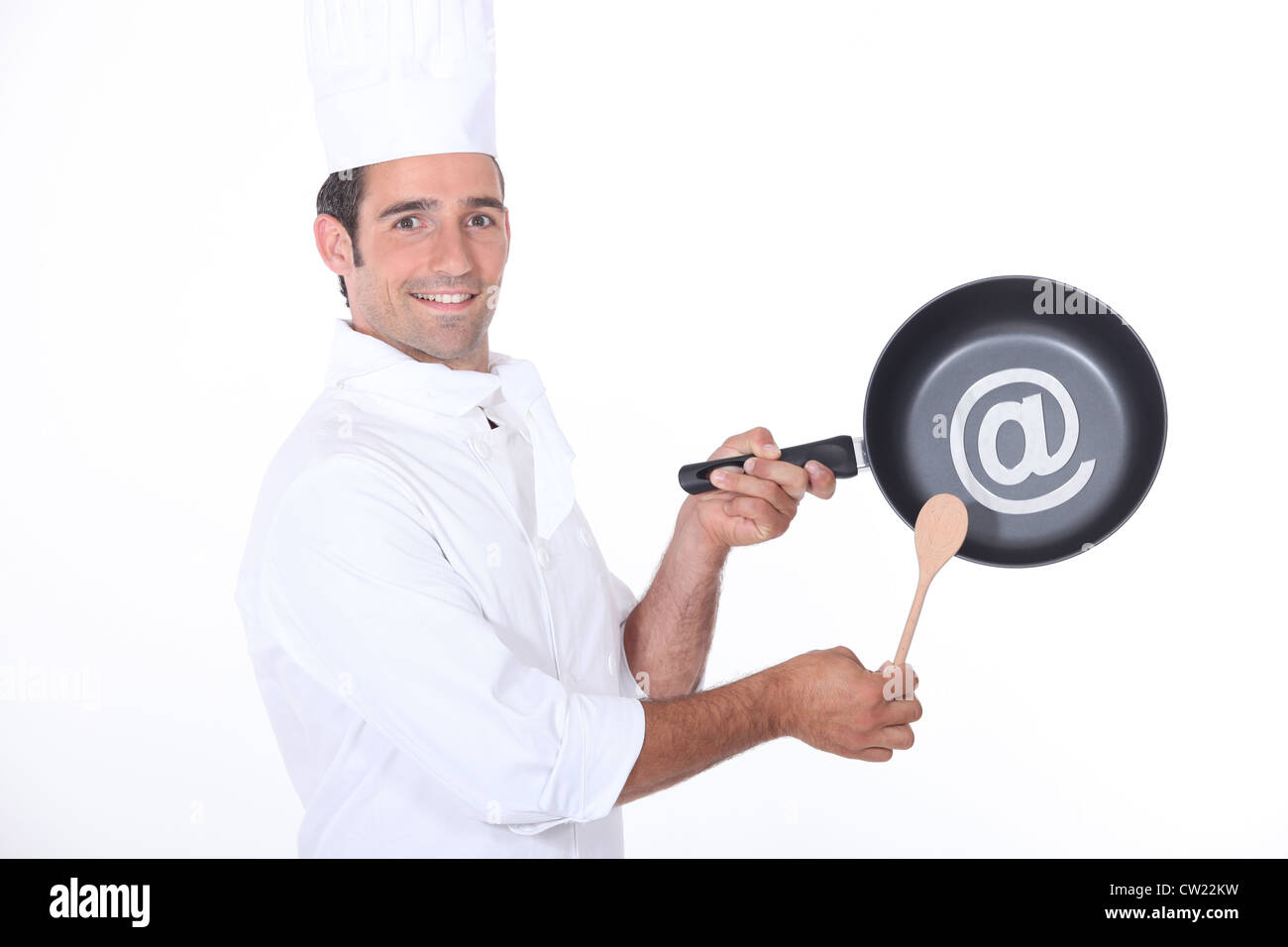 Chef holding pan in studio Stock Photo - Alamy