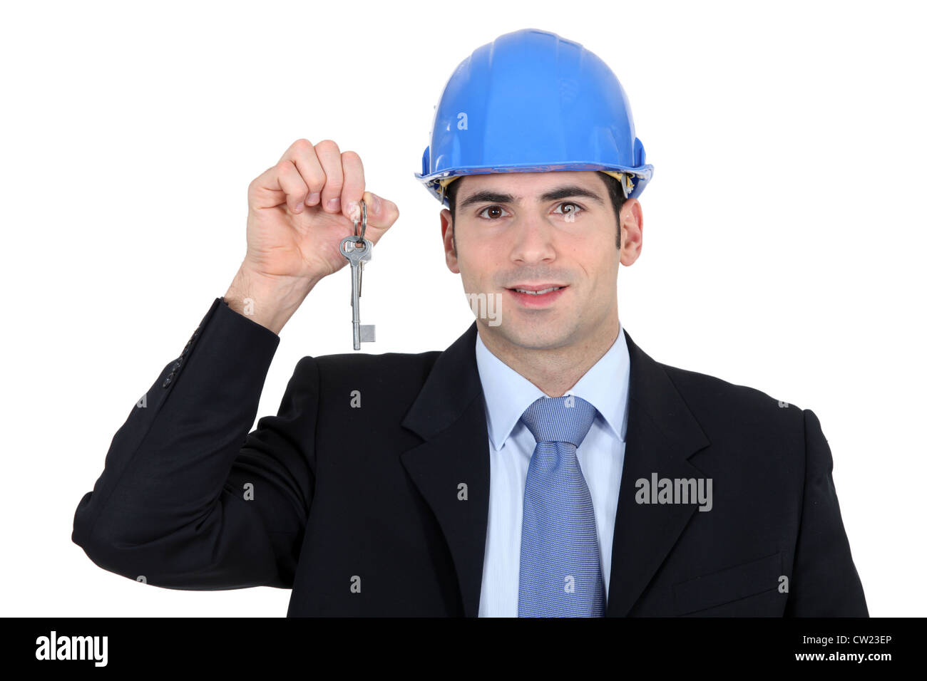 Engineer holding up a key Stock Photo - Alamy