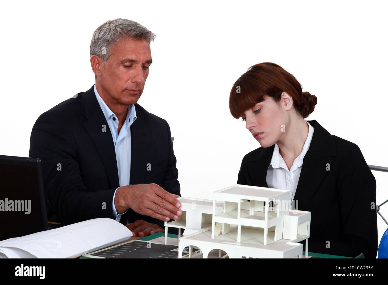 Architects examining a building model Stock Photo - Alamy