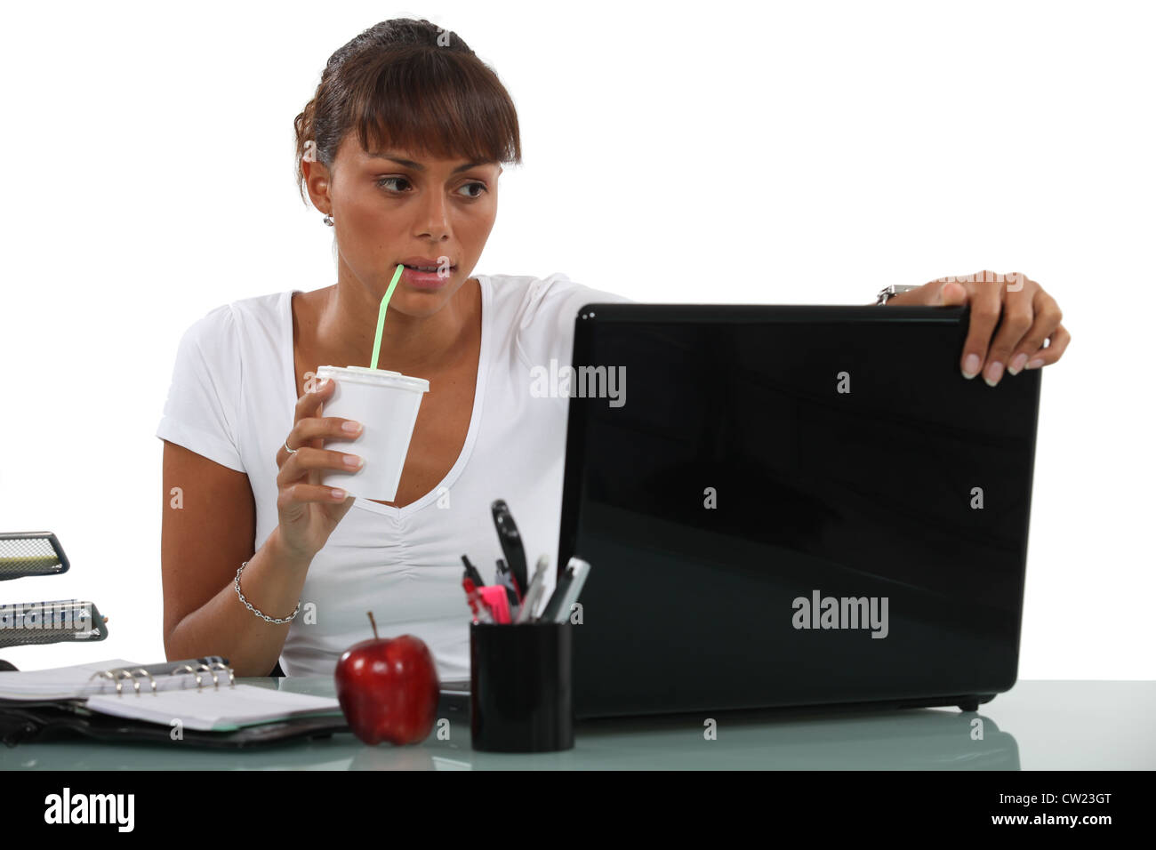 Business woman drinking at desk Stock Photo - Alamy