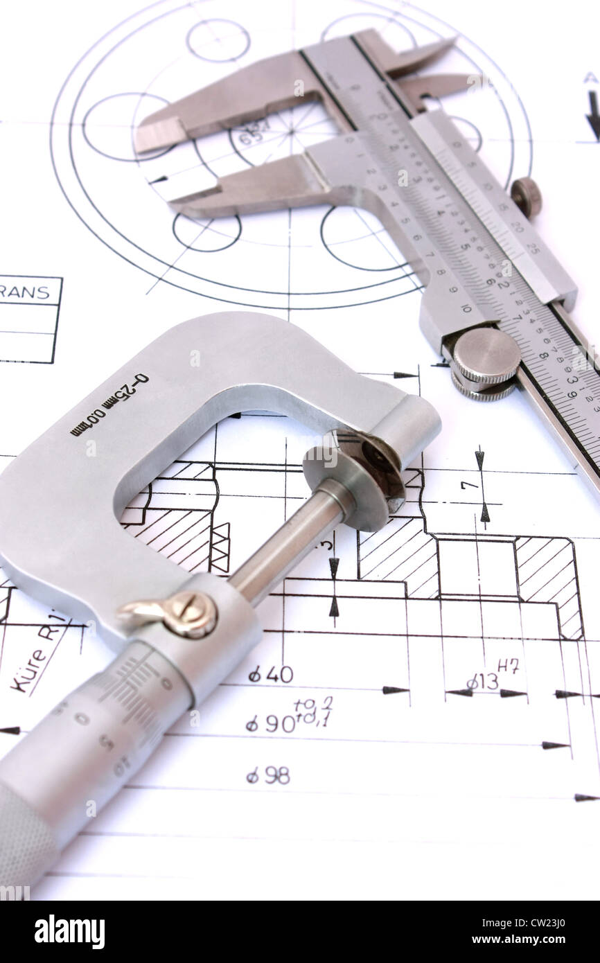 Caliper and Micrometer on blueprint vertical. Shallow depth of field ...