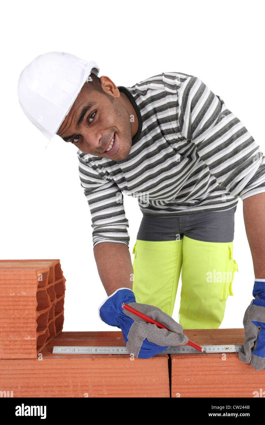 Bricklayer with a pencil and ruler Stock Photo - Alamy