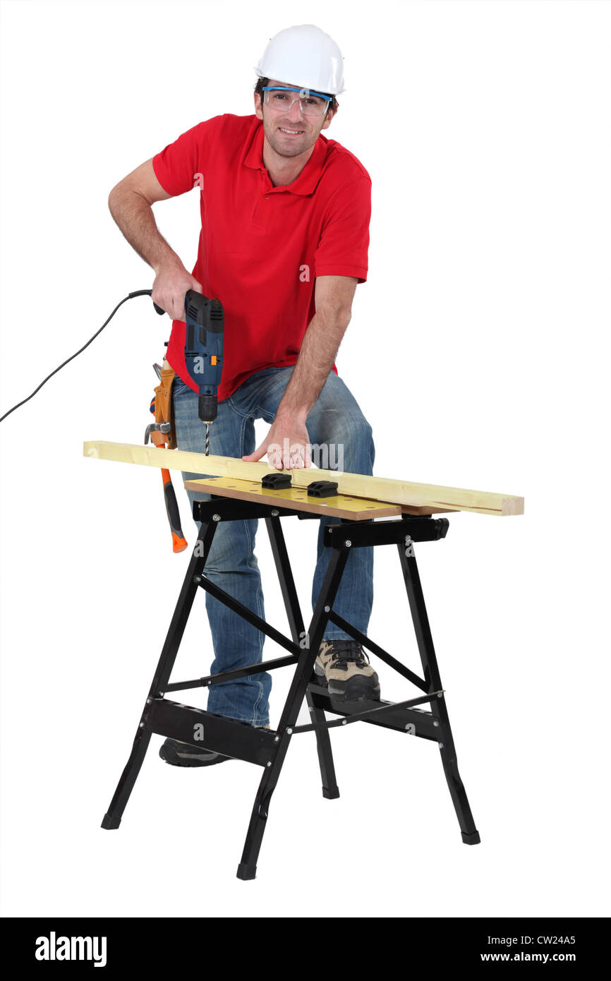 Tradesman using a power tool Stock Photo - Alamy