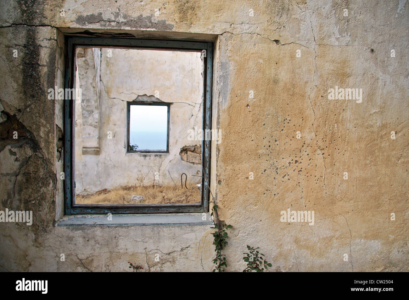 looking through the window of a derelict house and through another ...