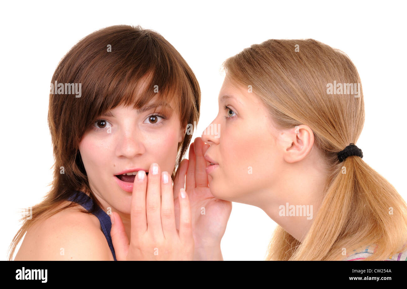 One young woman tell surprise news to another girl on white background ...