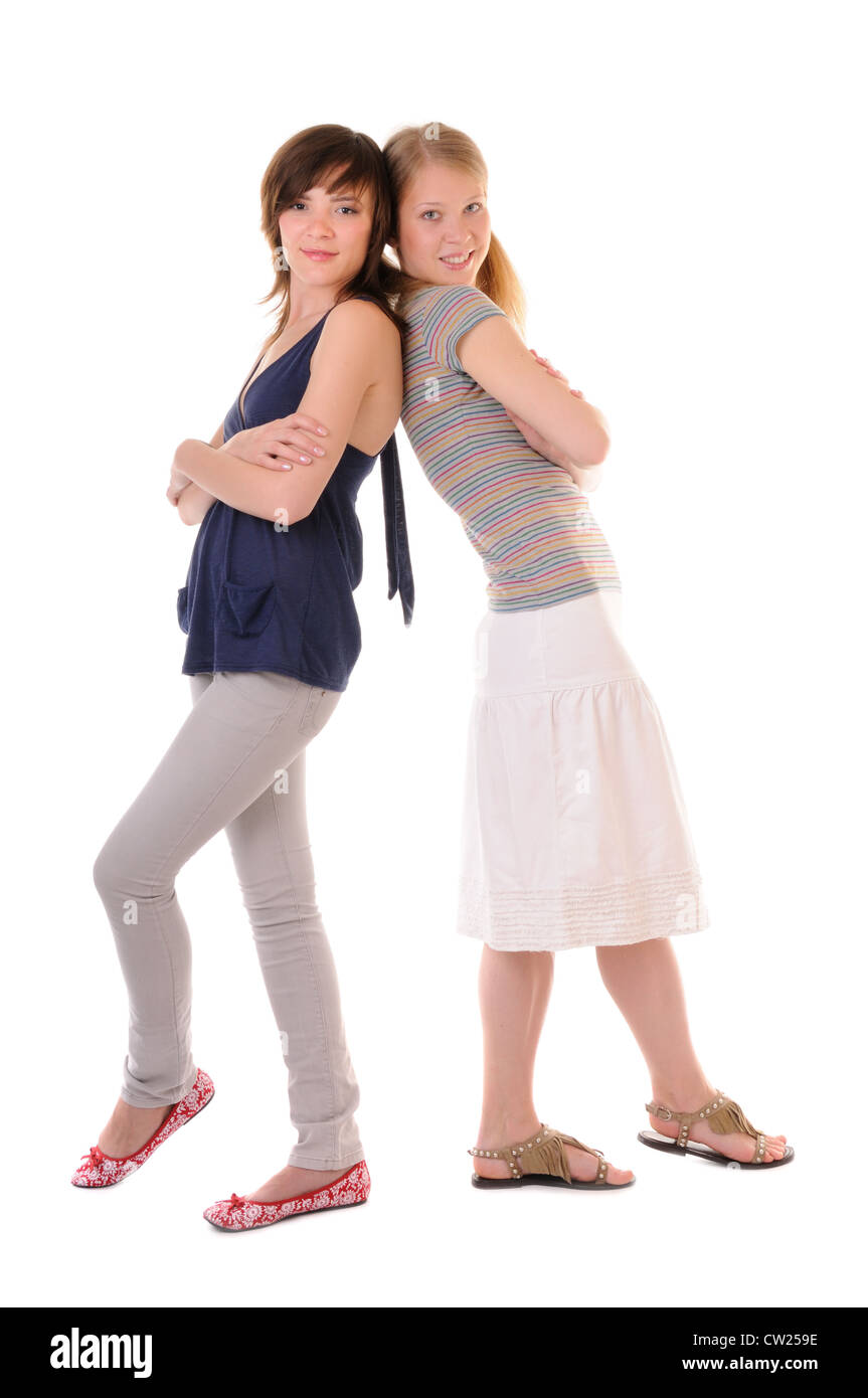 Two smilling girls are standing back-to-back on white background Stock ...
