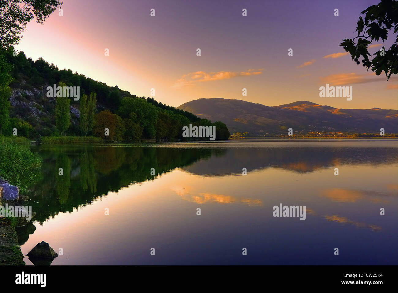 Reflection mountain with autumn colors, yellow trees into Kastoria lake ...
