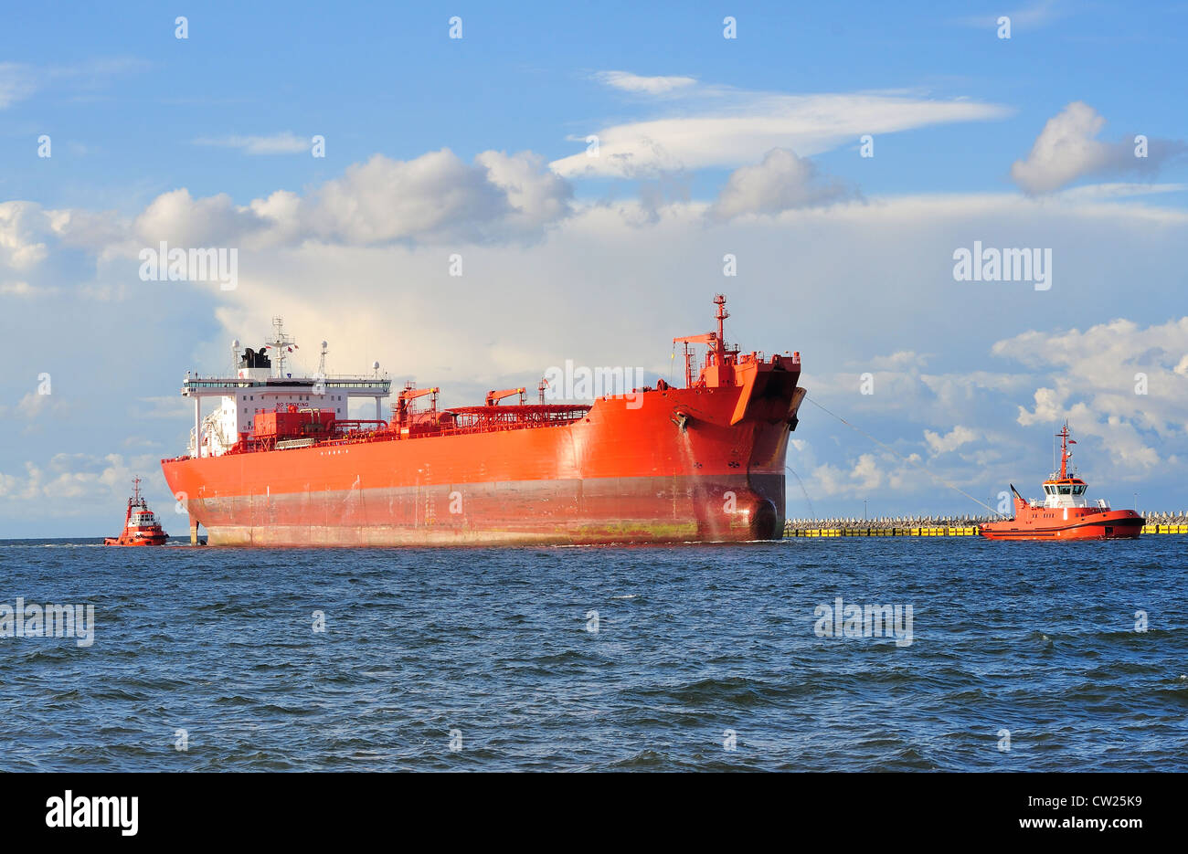 Big orange cargo ship heading for port Stock Photo - Alamy