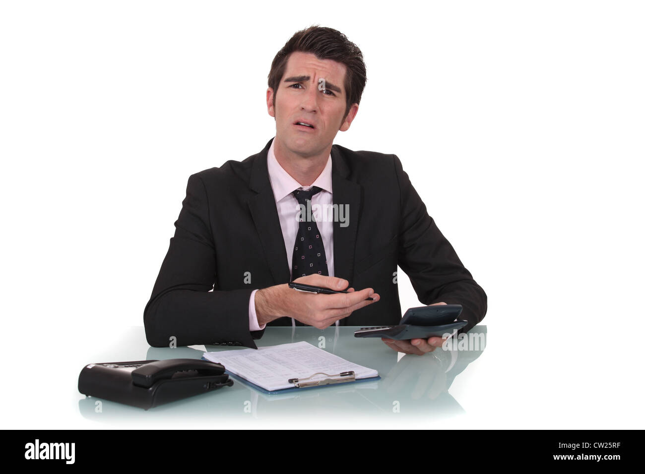 Confused businessman with a calculator Stock Photo - Alamy