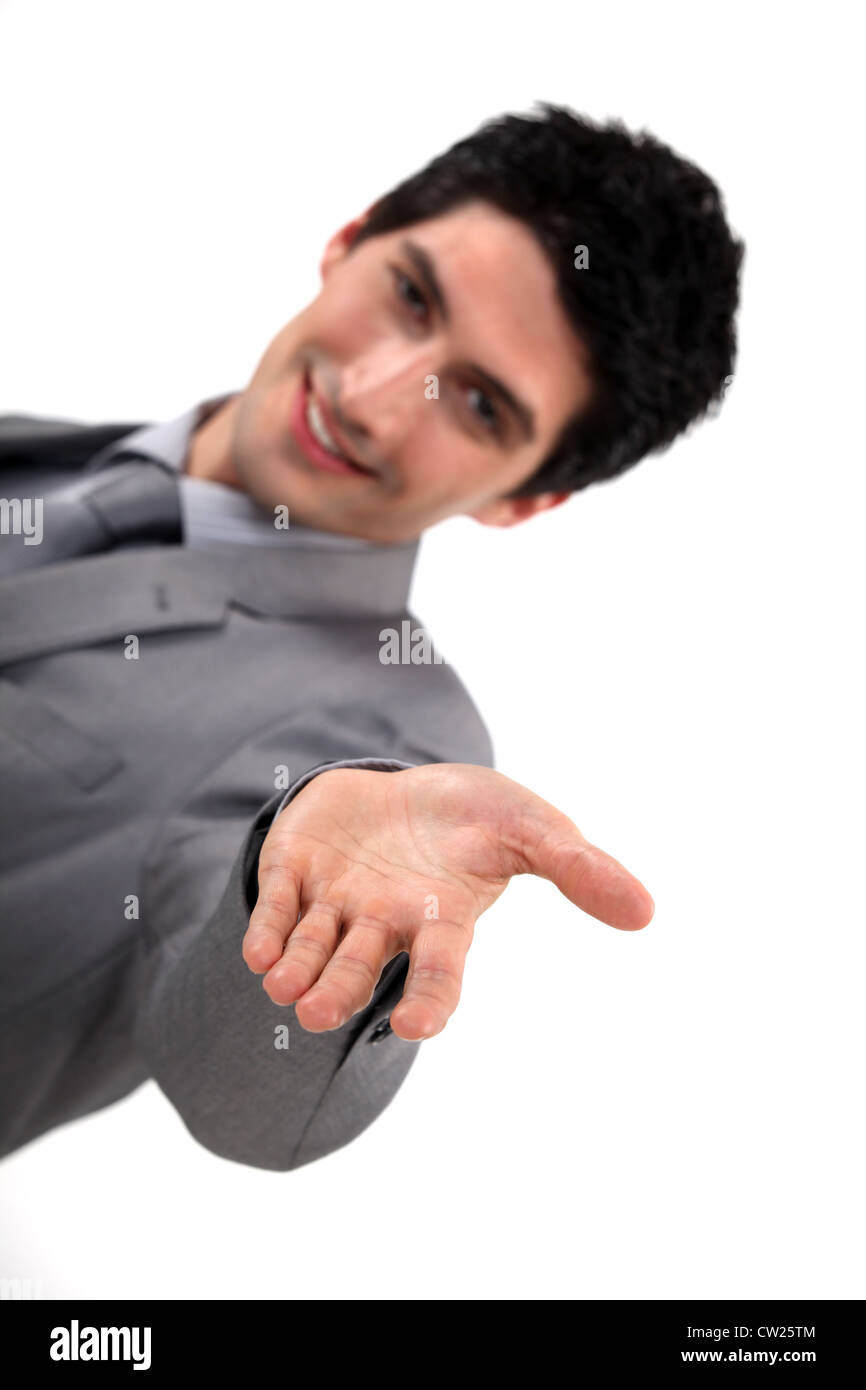 young handsome businessman reaching out his hand Stock Photo - Alamy
