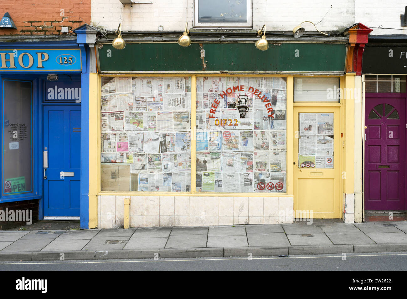 Chinese takeaway closed down with sheets of newspaper obscuring the ...