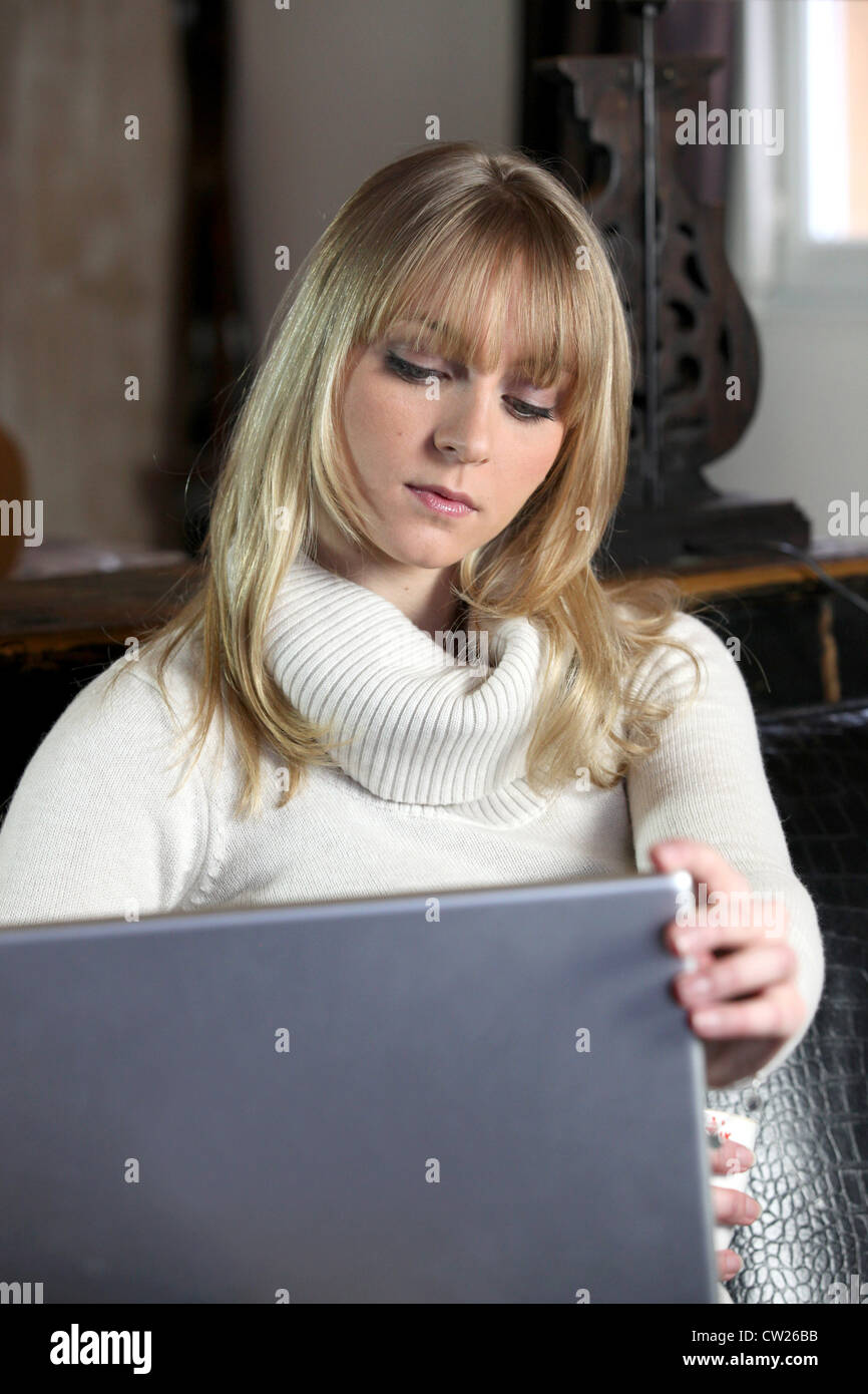 Serious woman using a laptop computer Stock Photo - Alamy