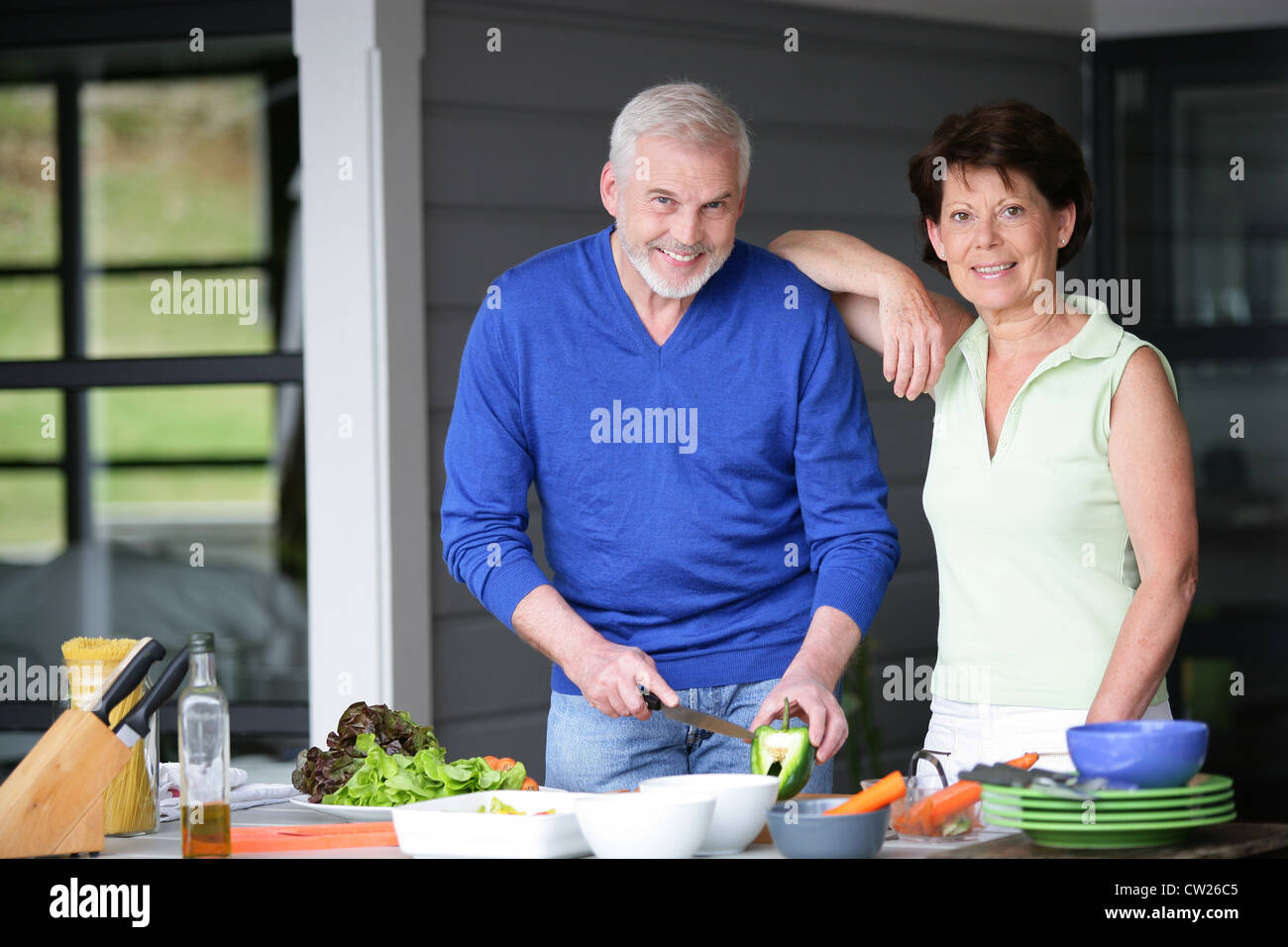 Middle-aged couple cooking outdoors together Stock Photo - Alamy