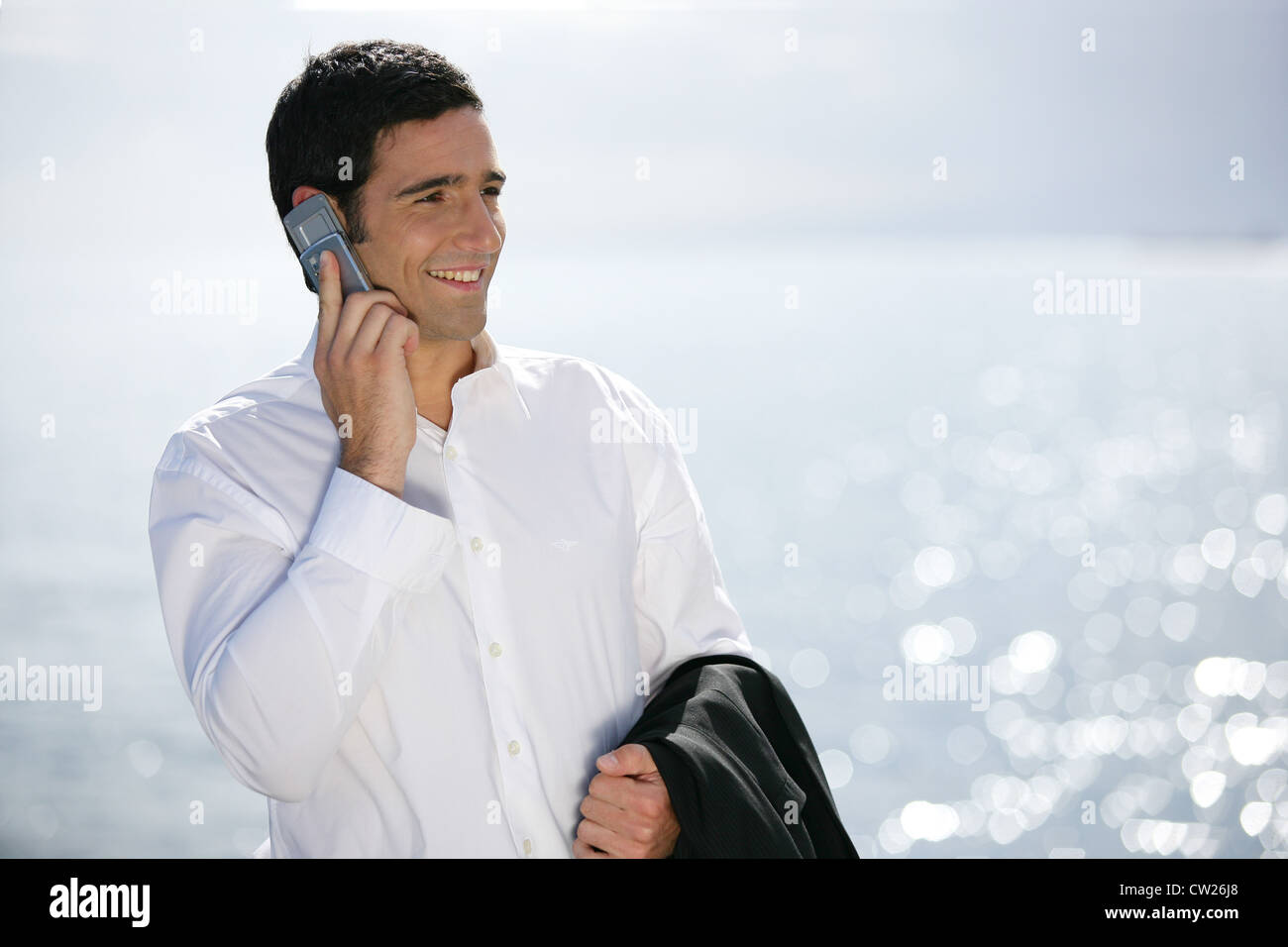 Businessman making call at the beach Stock Photo - Alamy