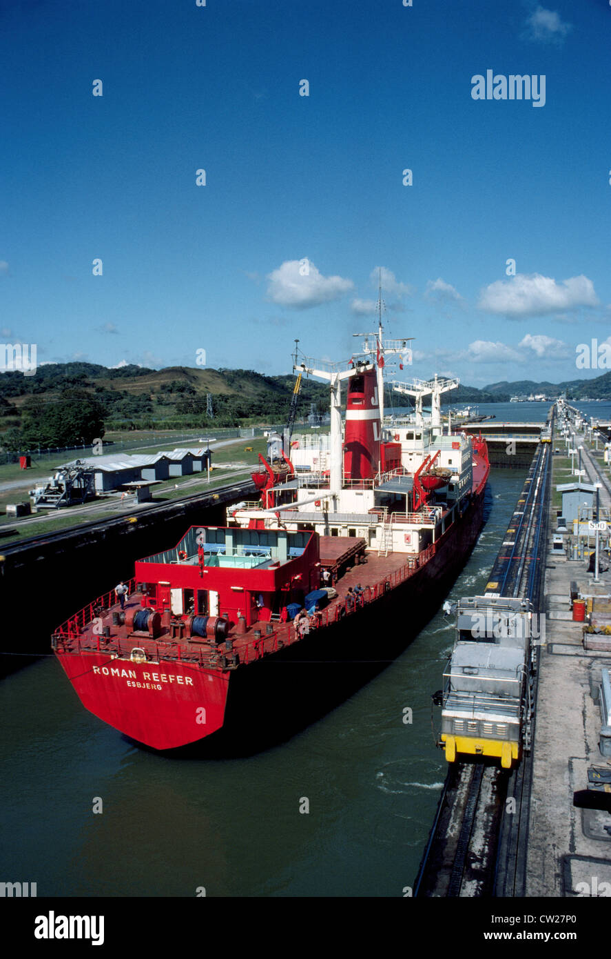 A red refrigerated cargo ship rises in the Miraflores Locks to pass ...