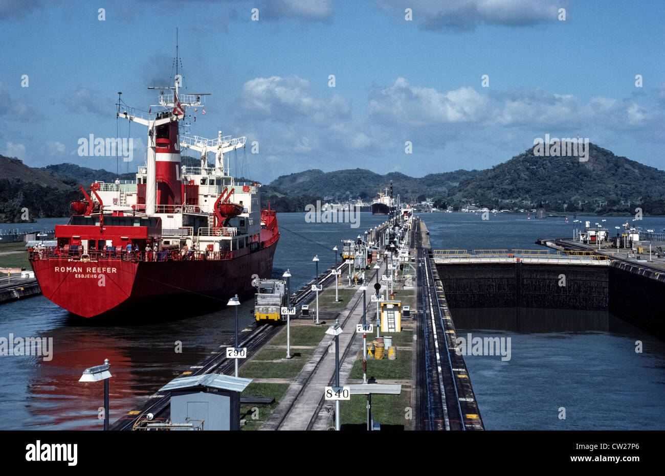 A red refrigerated cargo ship rises in the Miraflores Locks to pass ...