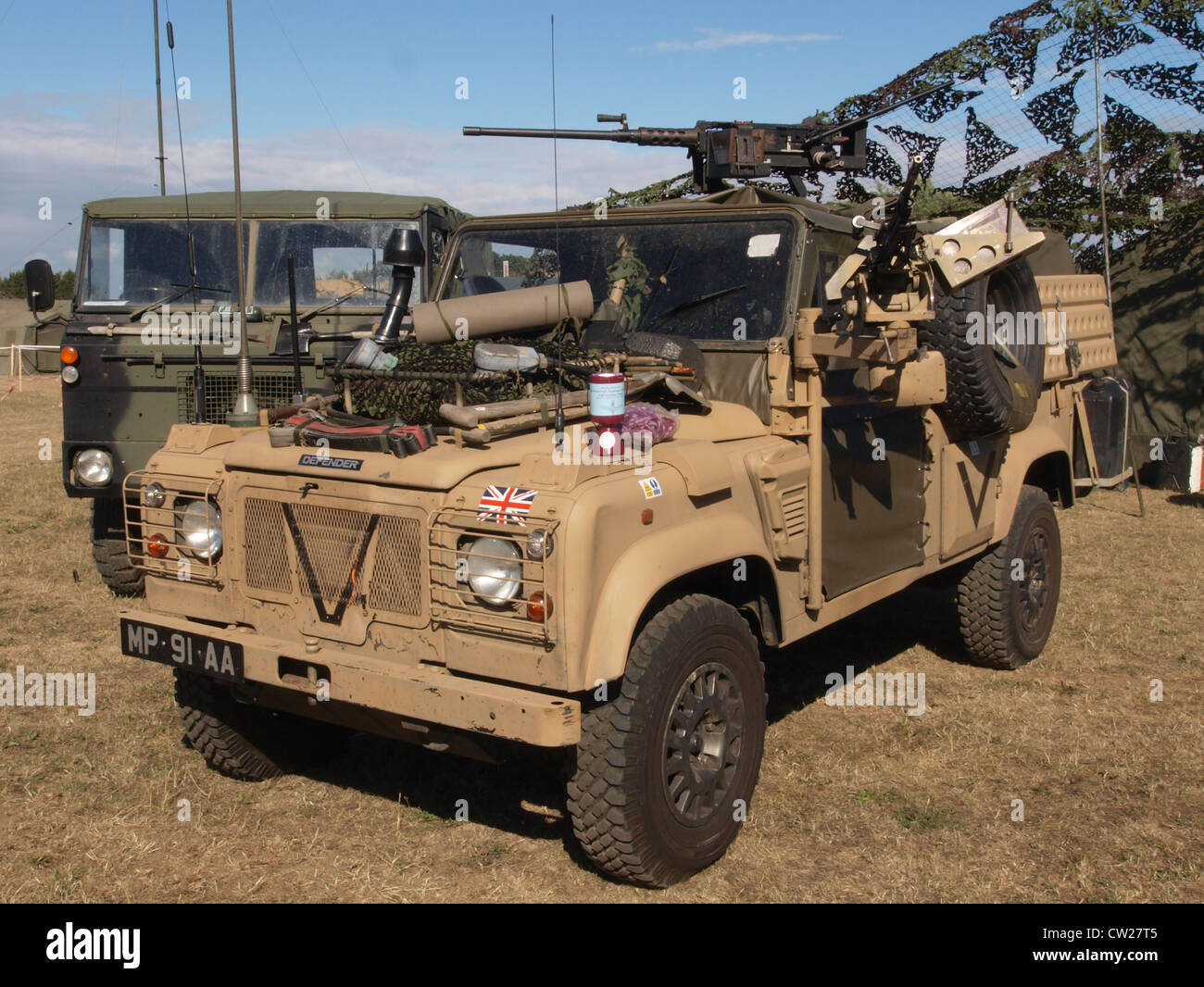 A Land Rover military vehicle, equipped with mounted artillery ...