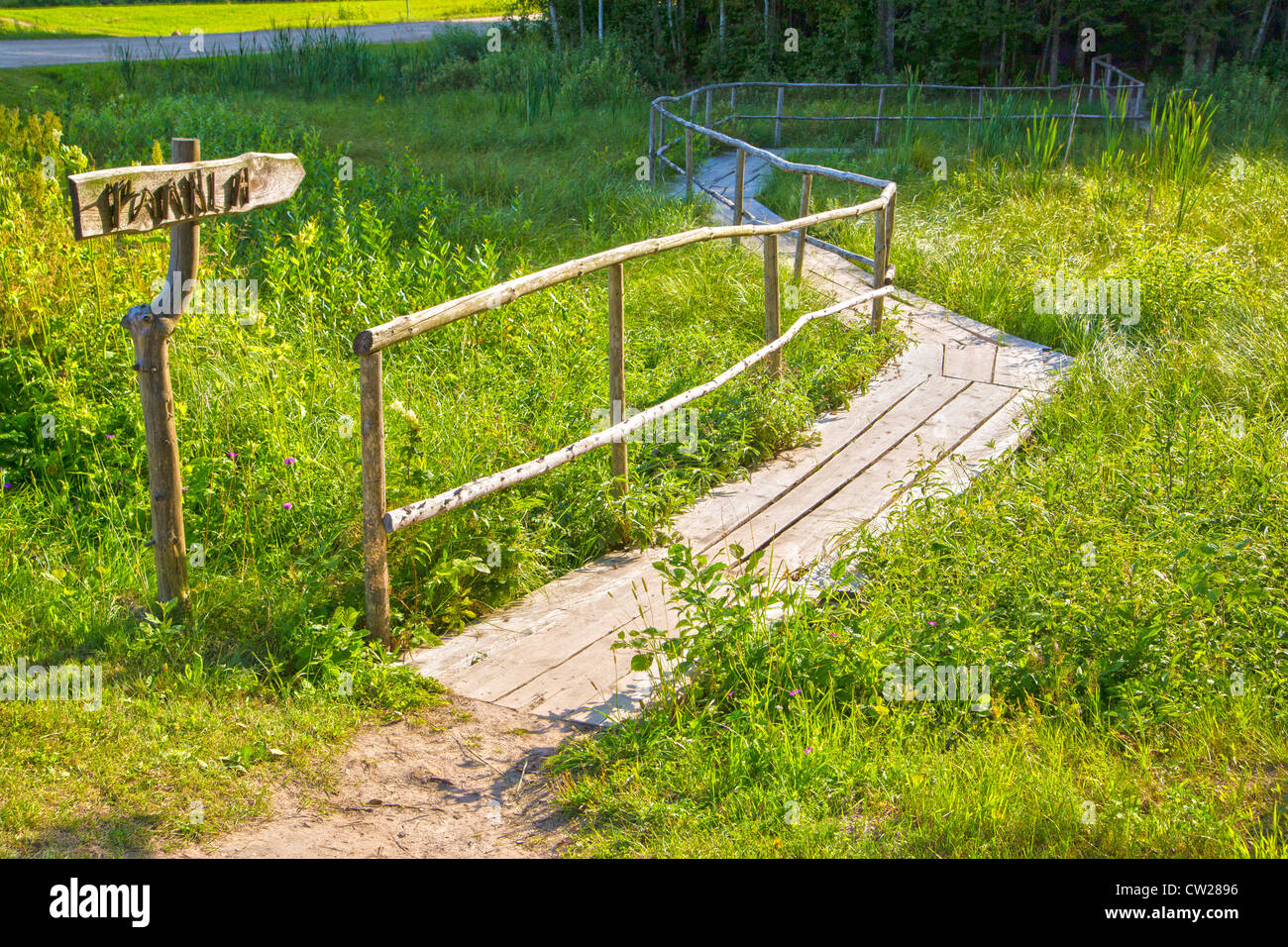 Sign maded from wooden plank lead through swamp Stock Photo - Alamy