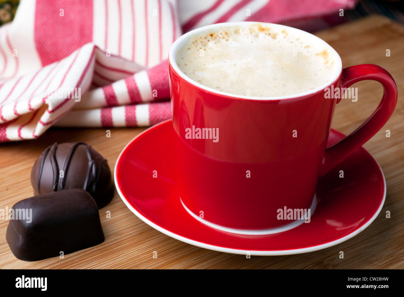Fresh latte and two chocolate candy for a well deserved break Stock ...
