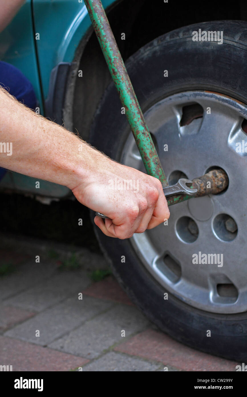 A car mechanic repairing broken wheel Stock Photo - Alamy