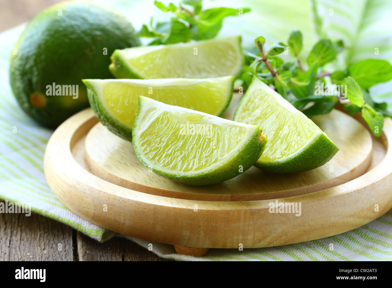 Fresh organic cut limes on wooden table Stock Photo - Alamy