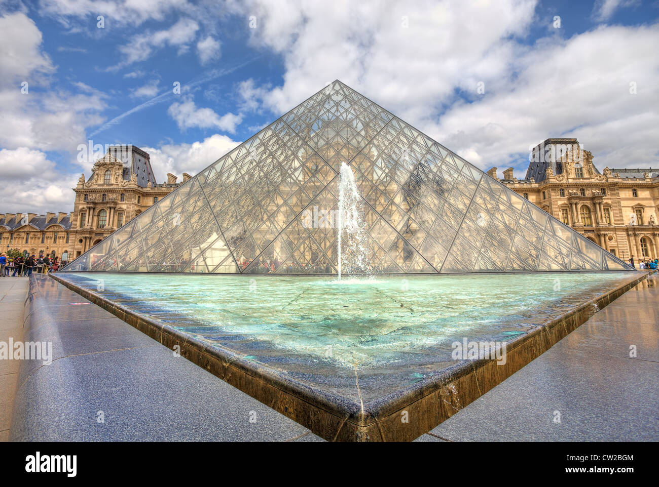 Famous glass Pyramid with fountain in Paris, France Stock Photo - Alamy