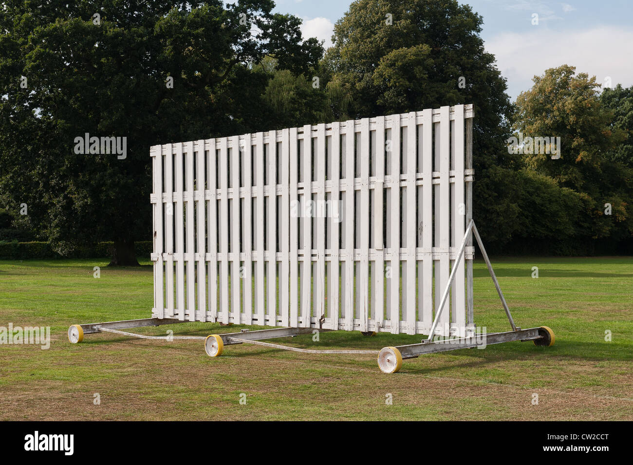 White painted wooden Village cricket sight screen well used on rollers ...