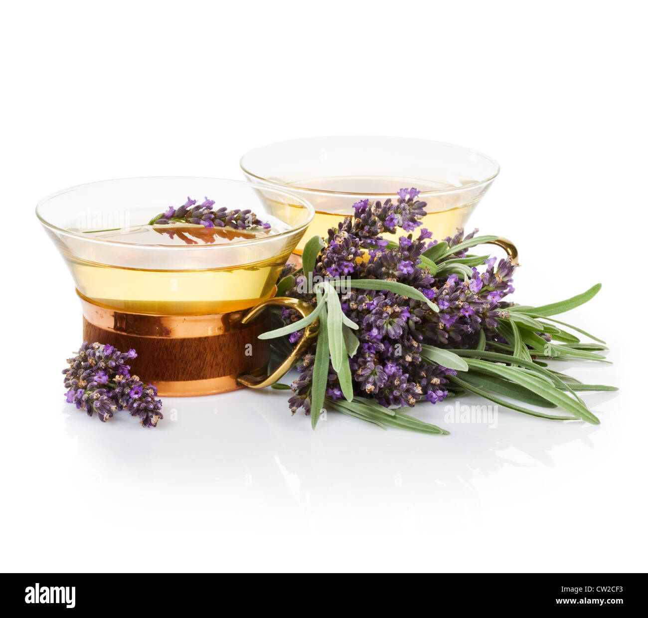 Two cups of lavender tea and bunch of fresh lavender on white ...