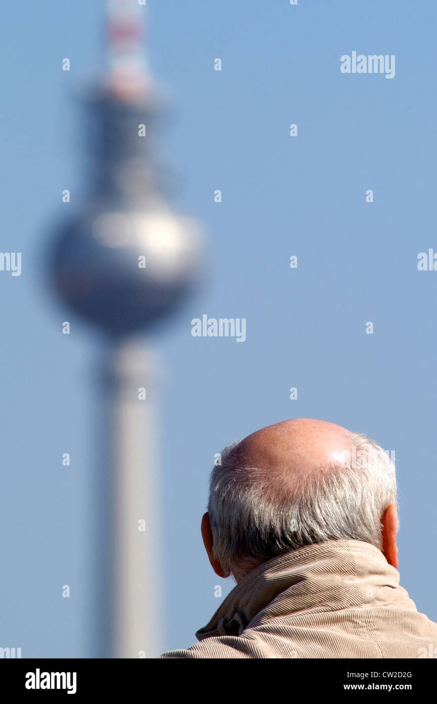 Bald man and the Berlin TV Tower Stock Photo - Alamy