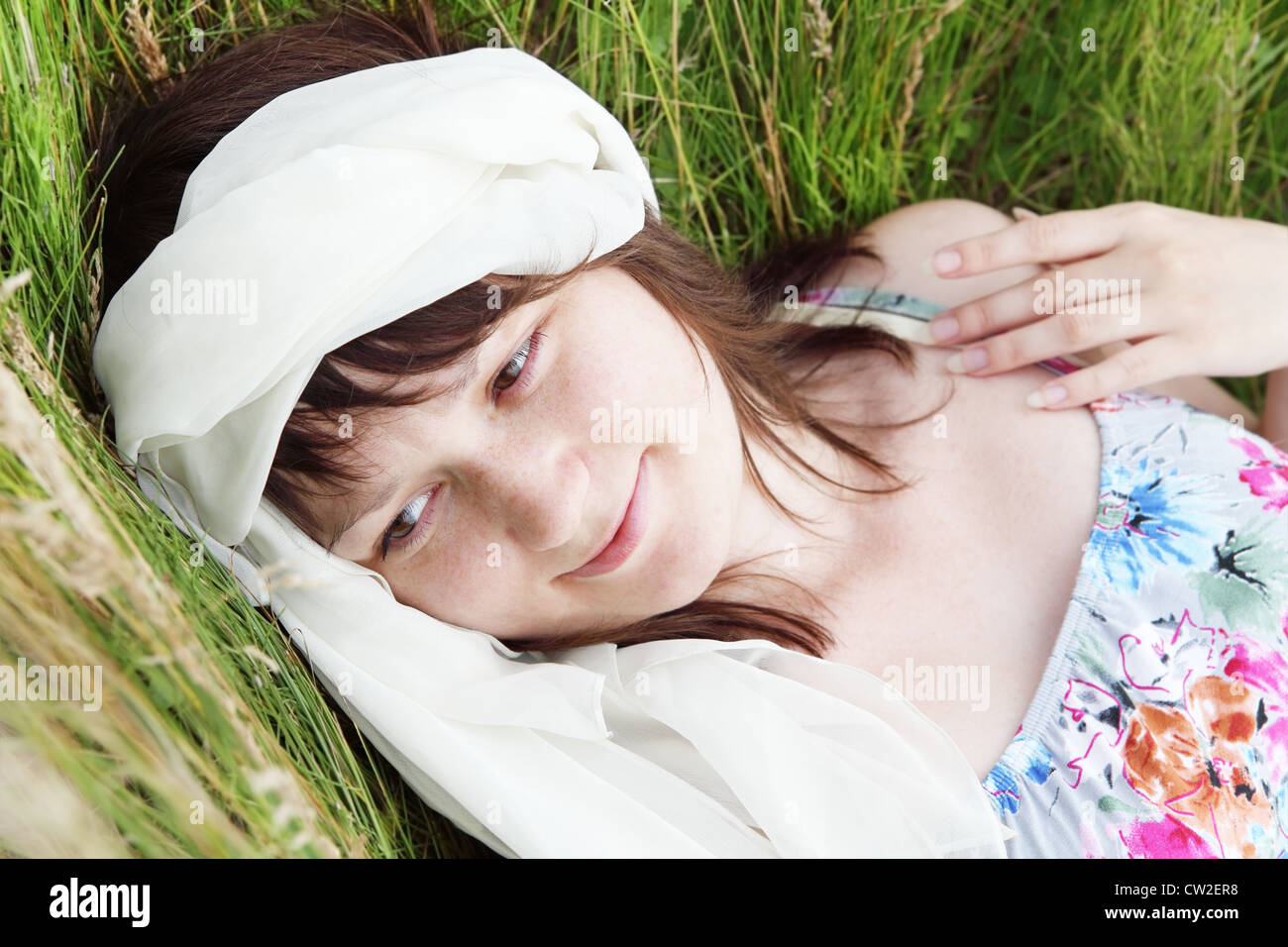 Young Woman Laying on Field Grass Portrait Stock Photo - Alamy