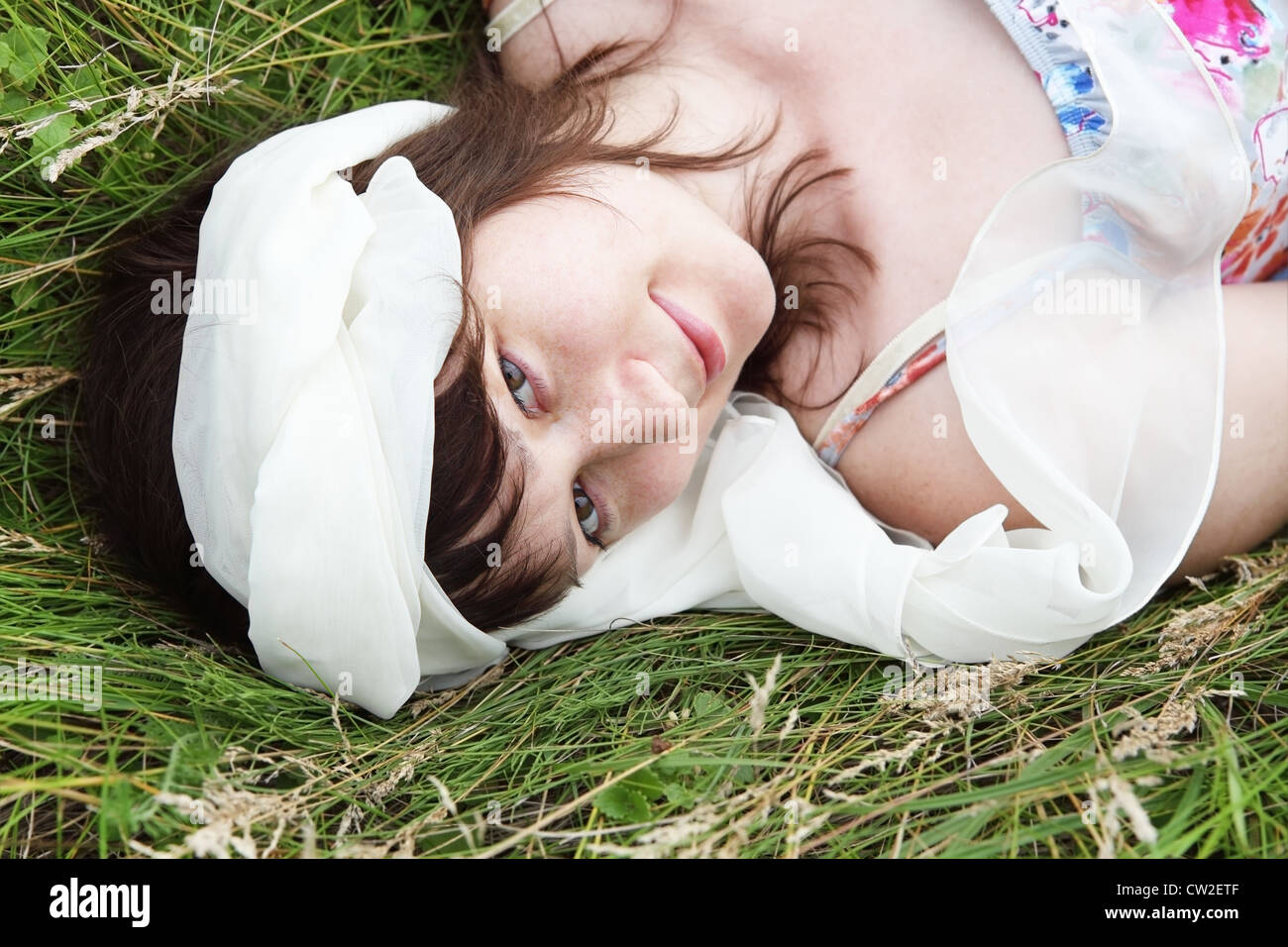 Young Woman Laying on Field Grass Portrait Stock Photo - Alamy
