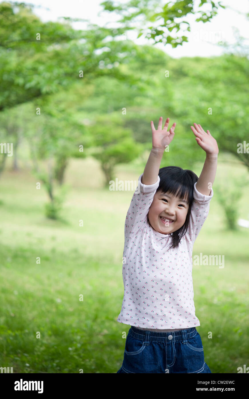 Girl with arms raised Stock Photo - Alamy