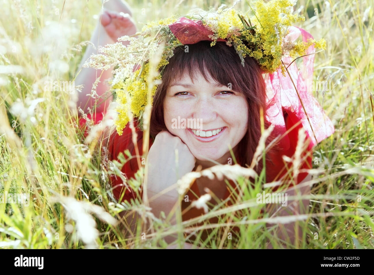 Young Woman Laying on Field Grass Portrait Stock Photo - Alamy