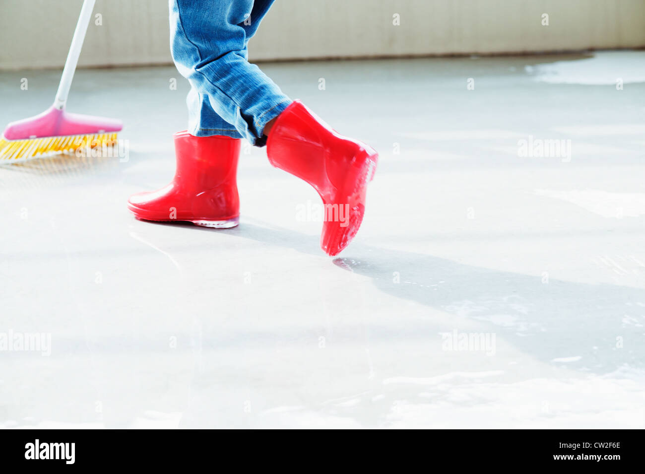 Girl cleaning with a broom Stock Photo - Alamy