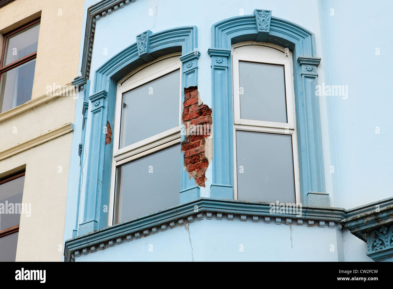 Seaside villa window with plaster crumbling away Stock Photo - Alamy