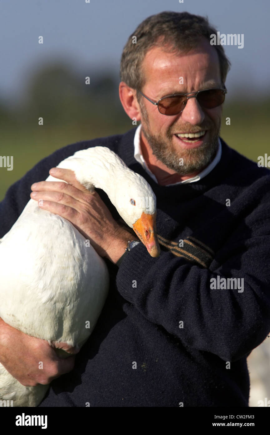 Farmer with free-range goose Stock Photo - Alamy