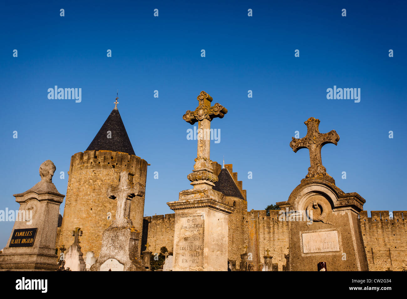 Intricately carved crosses and monuments in graveyard in old walled ...