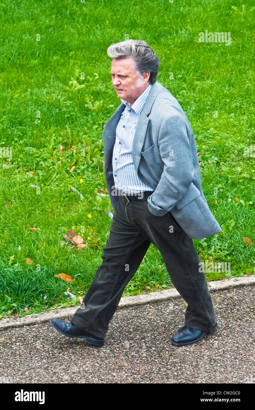 Overhead view of man walking along pavement - France Stock Photo - Alamy