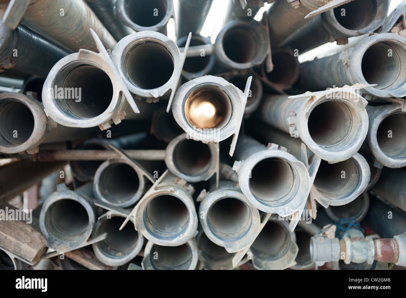 Side view of a pile of metal pipes Stock Photo - Alamy