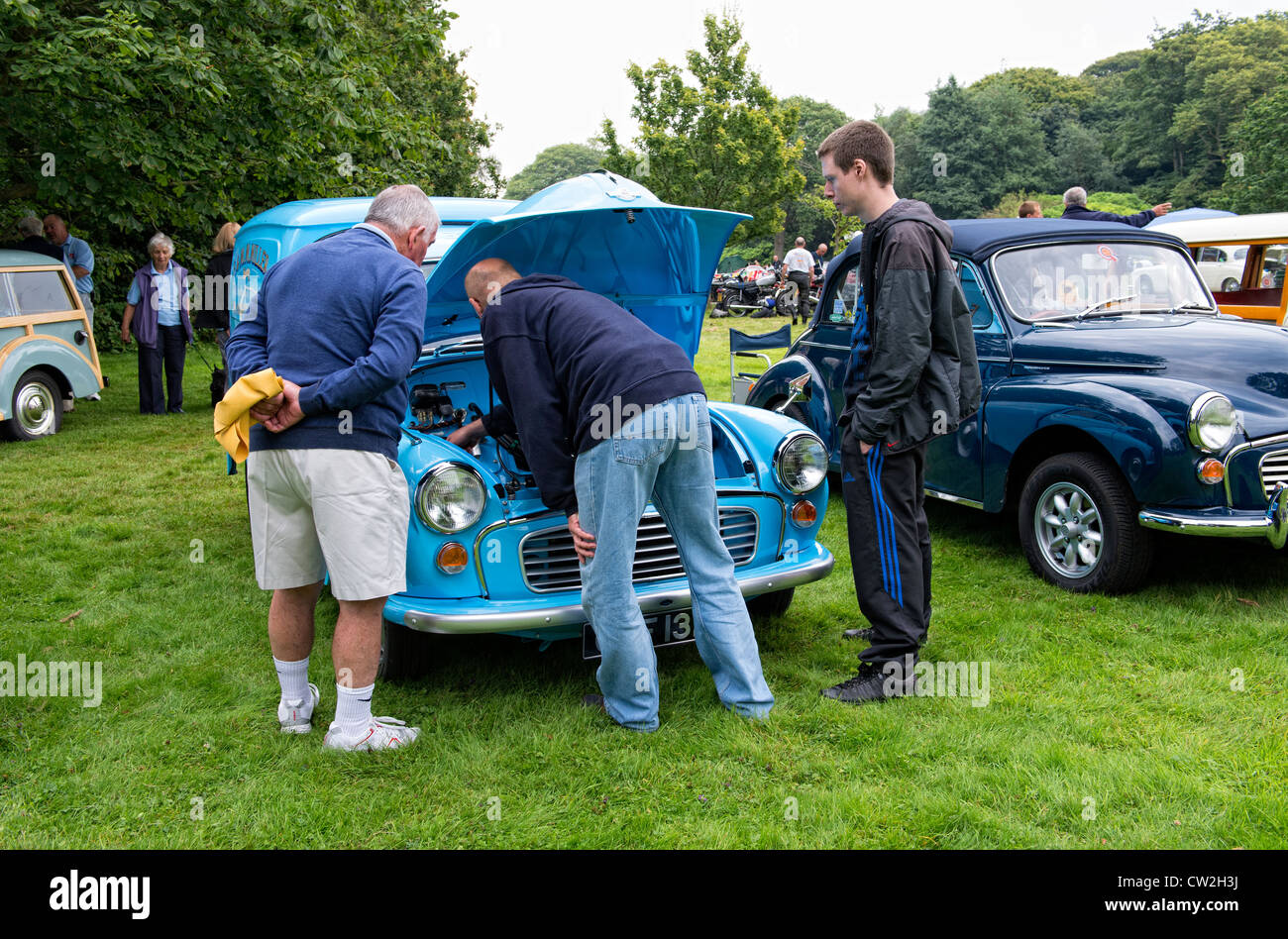 Classic Morris Minor motor car with enthusiasts at a classic car show ...