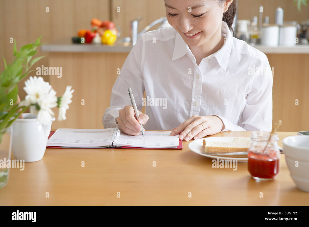 Woman writing a diary Stock Photo - Alamy